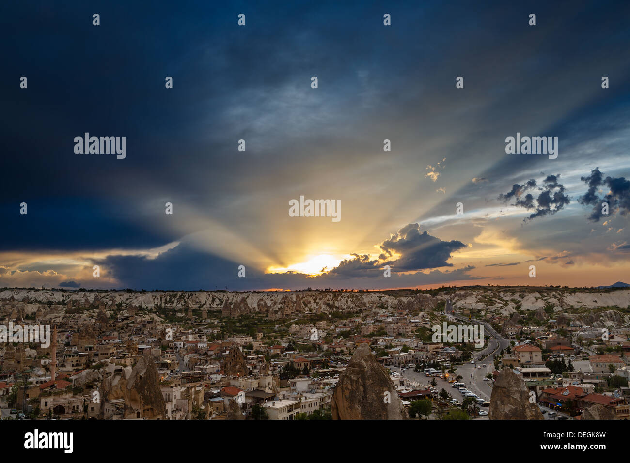 Clouds in the light of sunset over the town in mountains Stock Photo ...