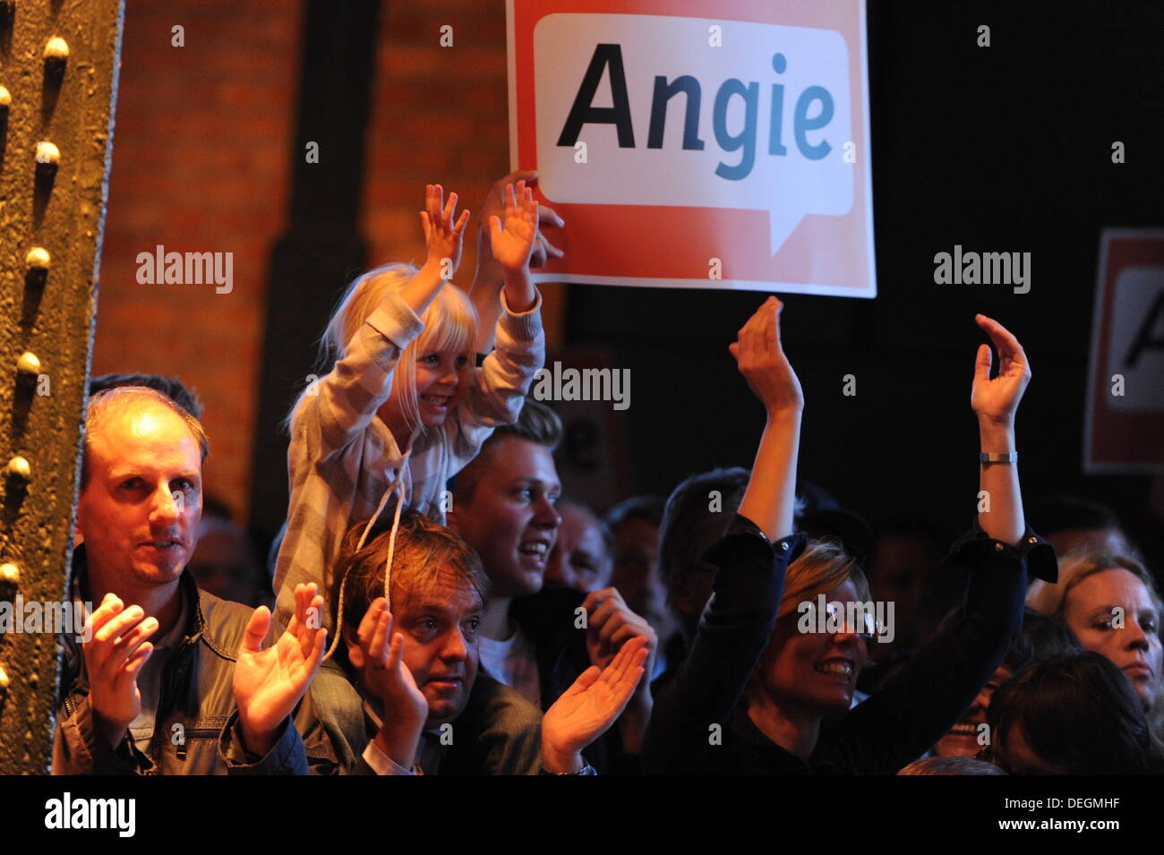 Supporters of German Chancellor Angela Merkel (hols up signs during an ...