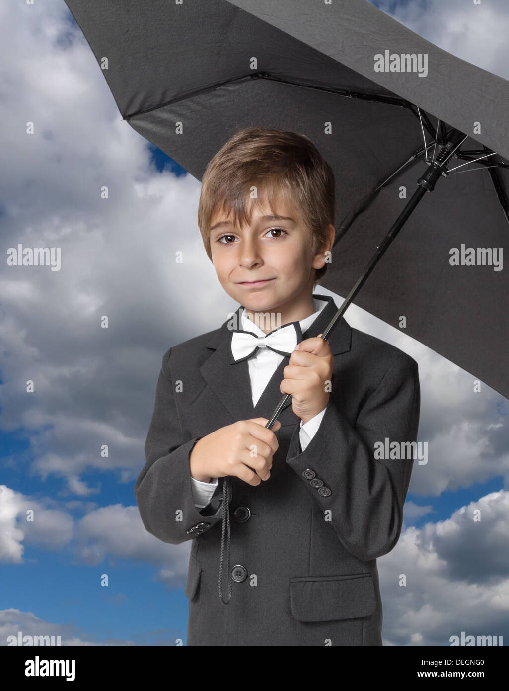 Boy under an umbrella on a sky background Stock Photo - Alamy