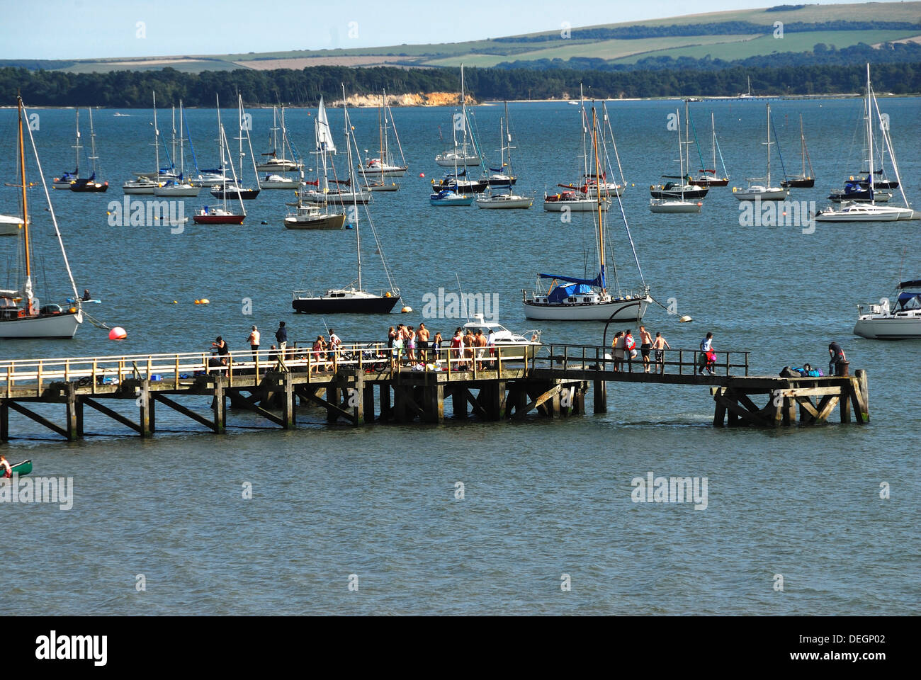 Boats and a pier in Poole harbour Dorset Stock Photo - Alamy