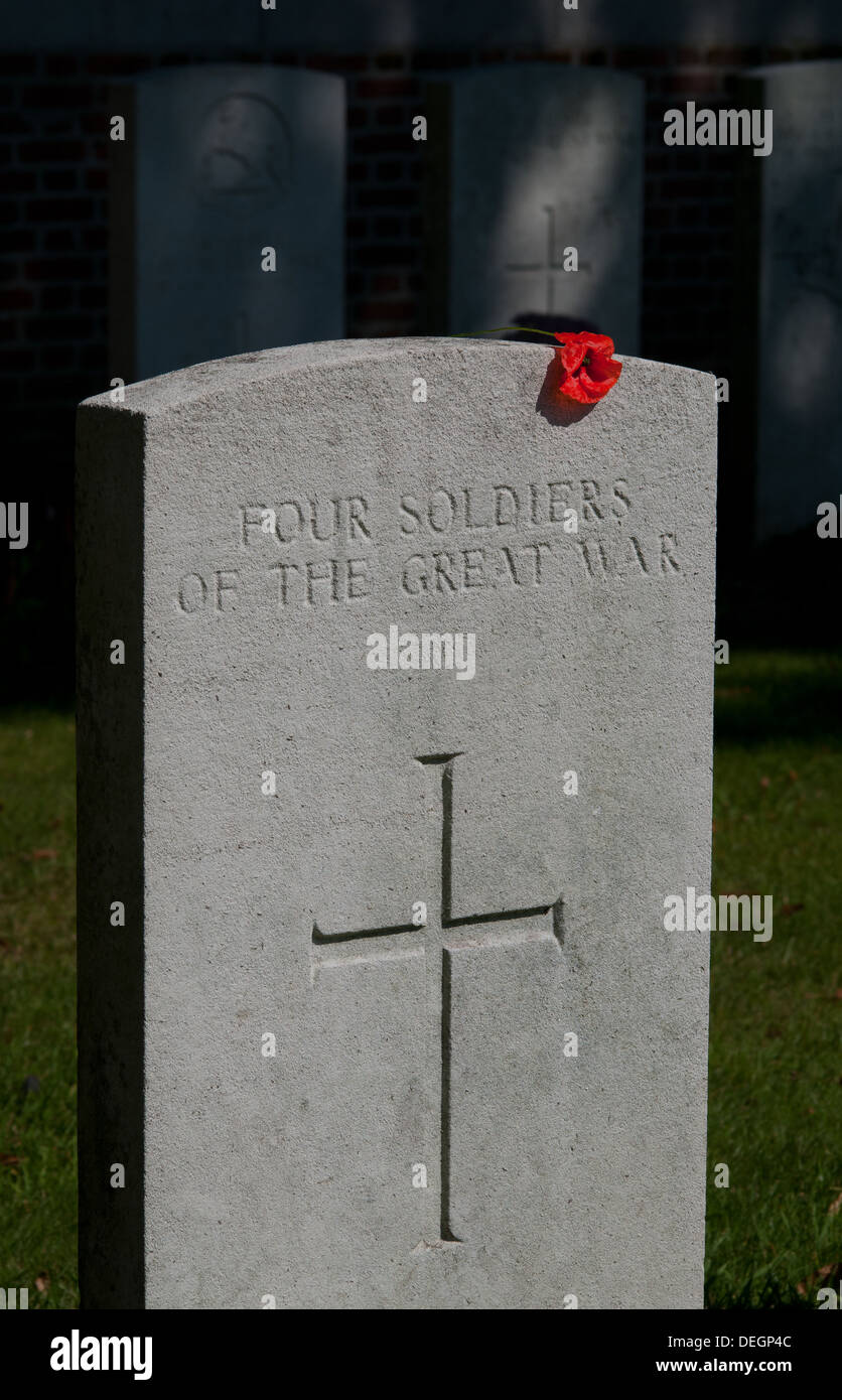 Poppy on headstone in British war cemetery Sucrerie at Colincamps ...
