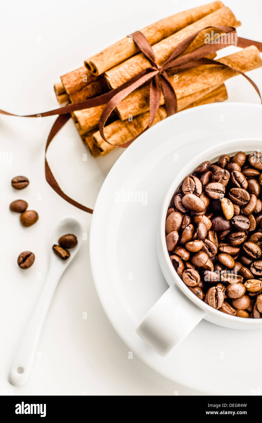 coffee beans in a cup and cinnamon tied with brown ribbon Stock Photo ...