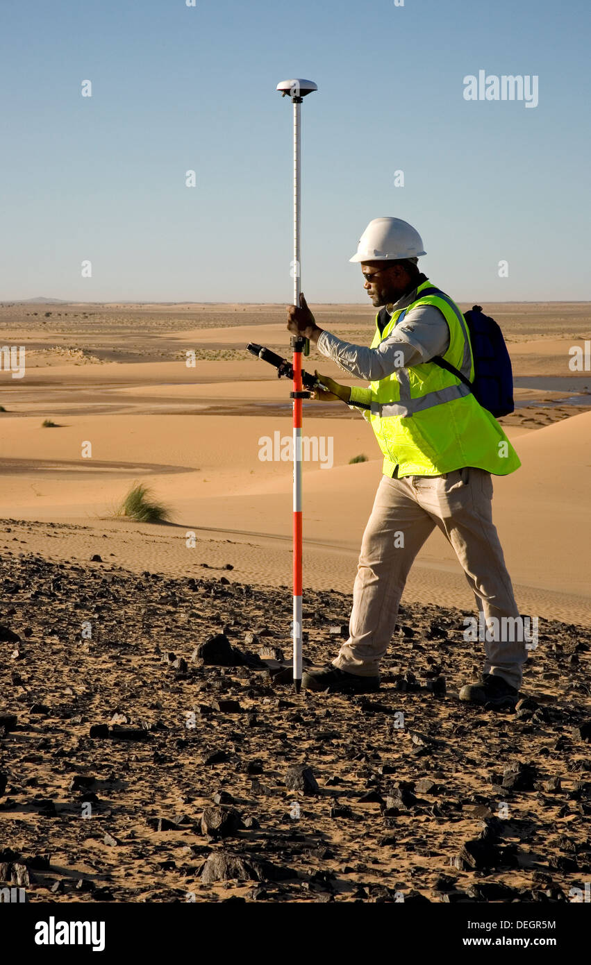 Geological surveyor using differential GPS equipment for a digital ...