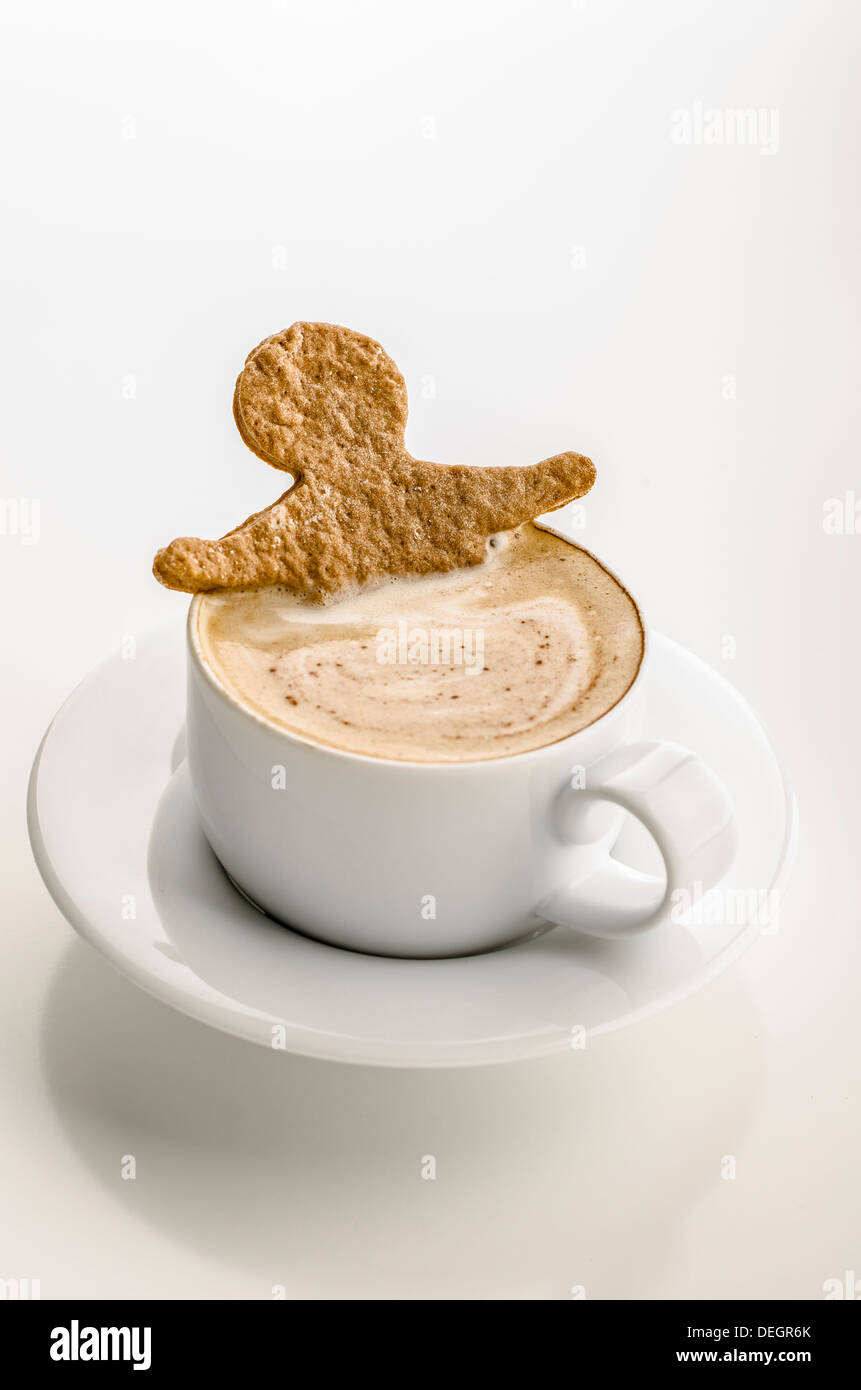 Gingerbread man in a cup of coffee Stock Photo - Alamy
