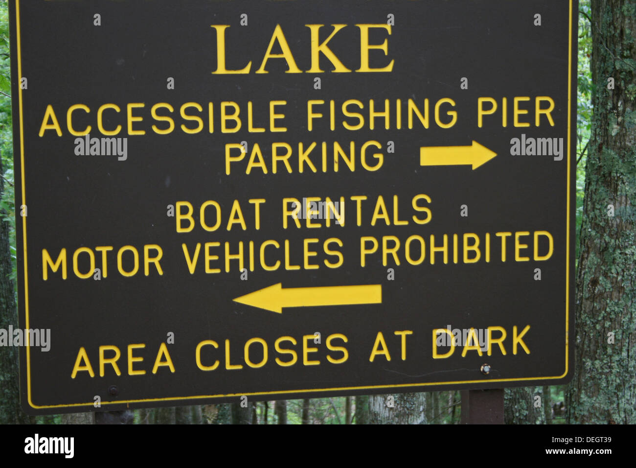 Wooden sign detailing lake access Stock Photo - Alamy