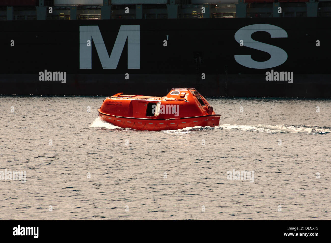 A commercial shipping lifeboat, under way in harbour Stock Photo - Alamy