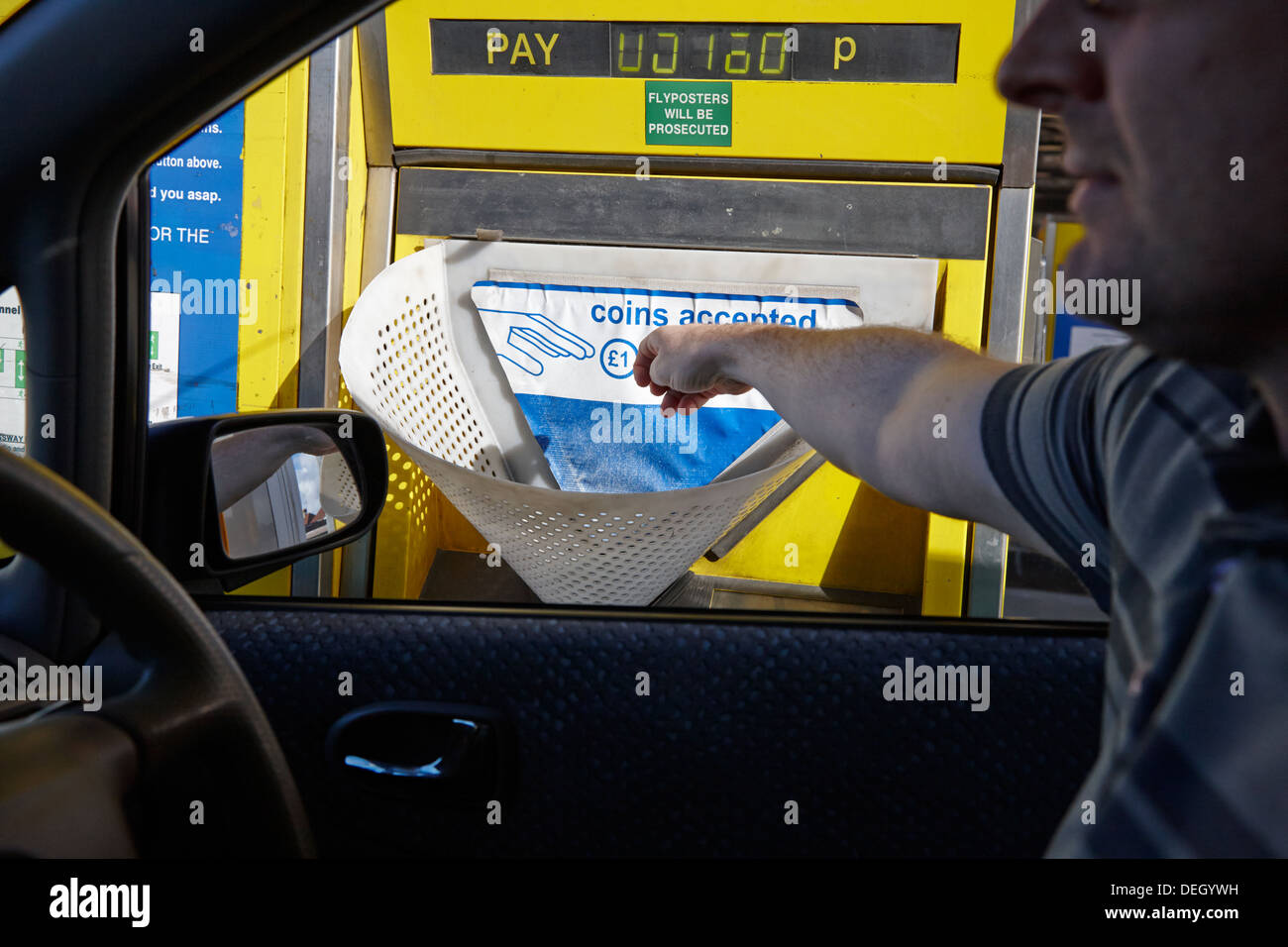 man making cash payment at toll booths at birkenhead kingsway tunnel ...