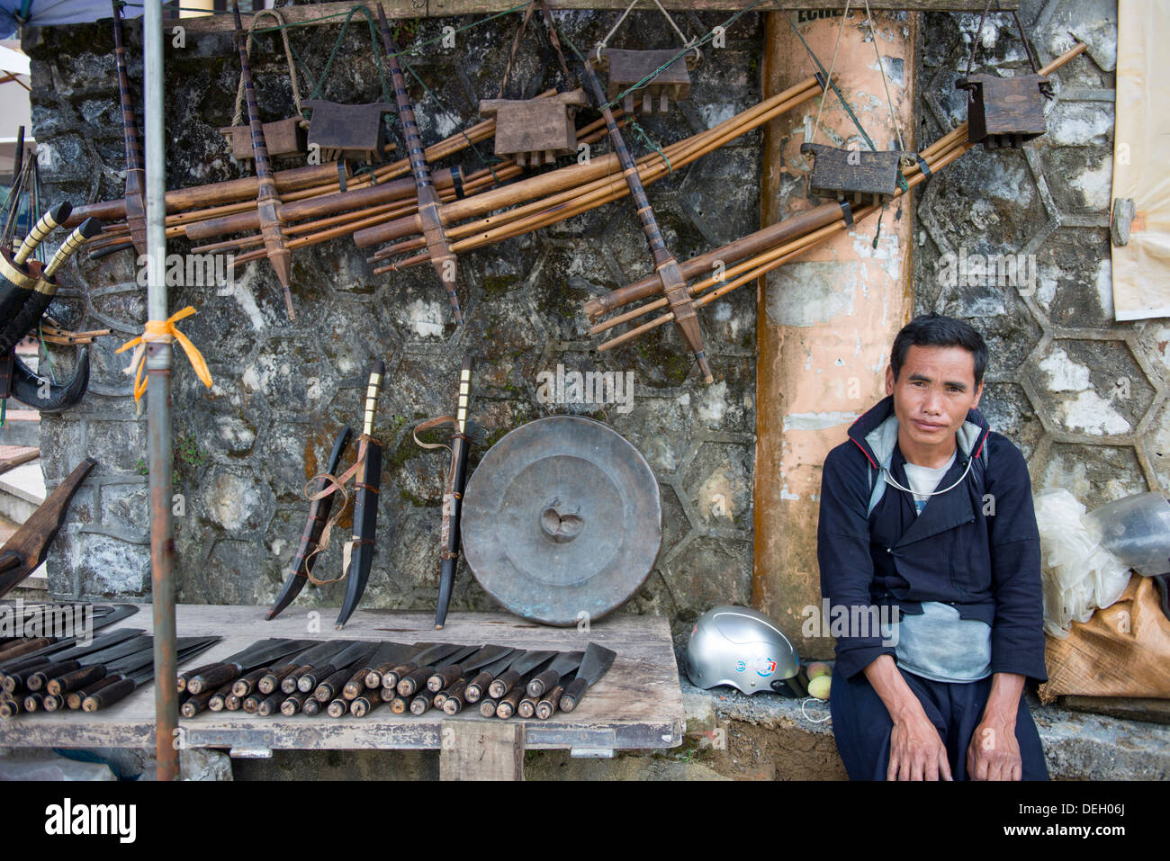 Ethnic group Black Hmong vendor shop owner with his tools and ...