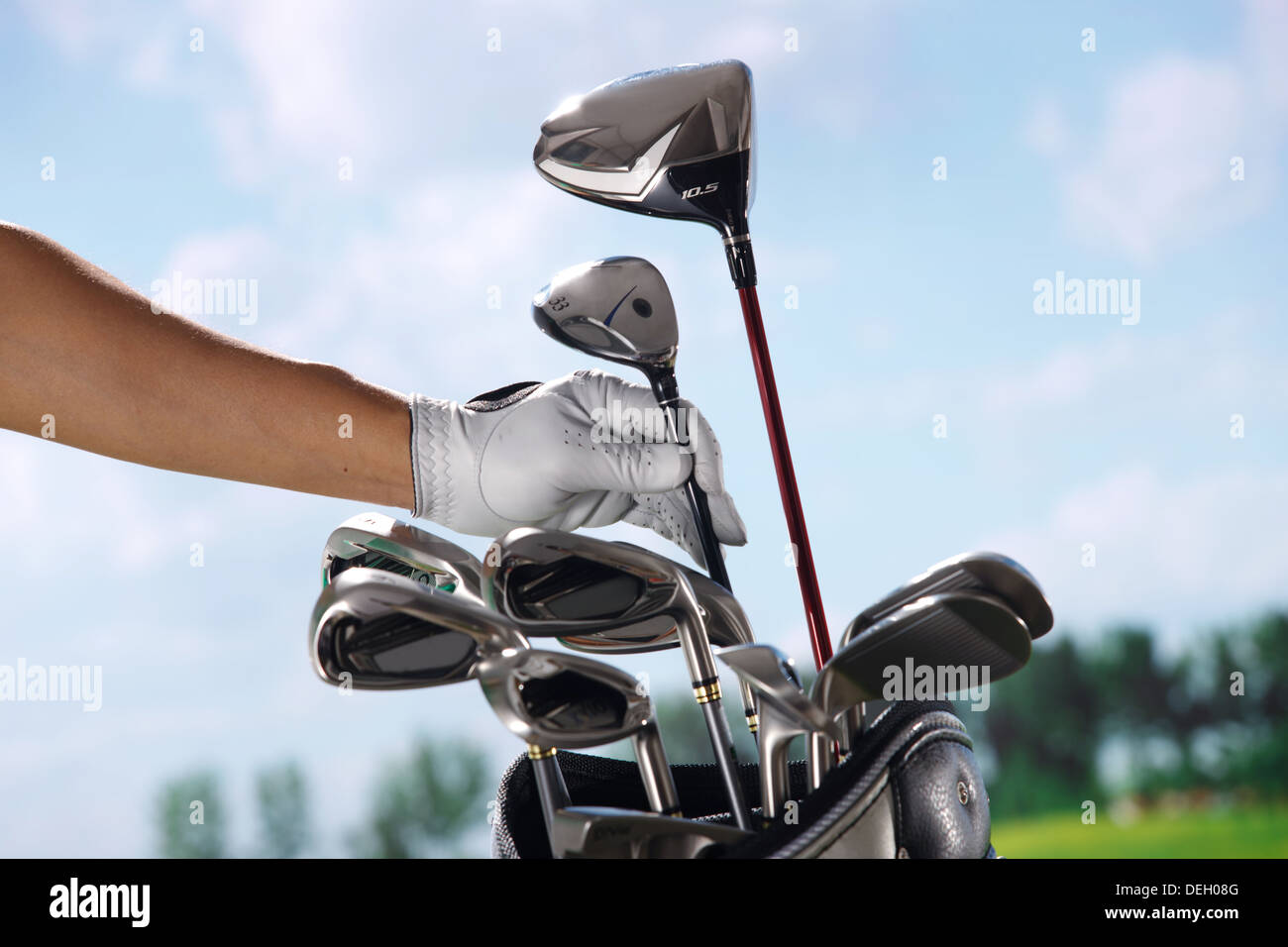 Removing golf club from bag Stock Photo - Alamy