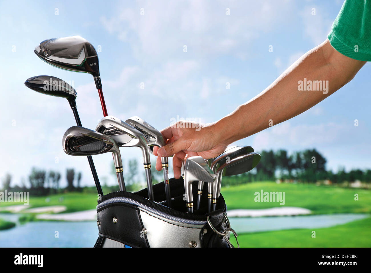 Removing golf club from bag Stock Photo - Alamy