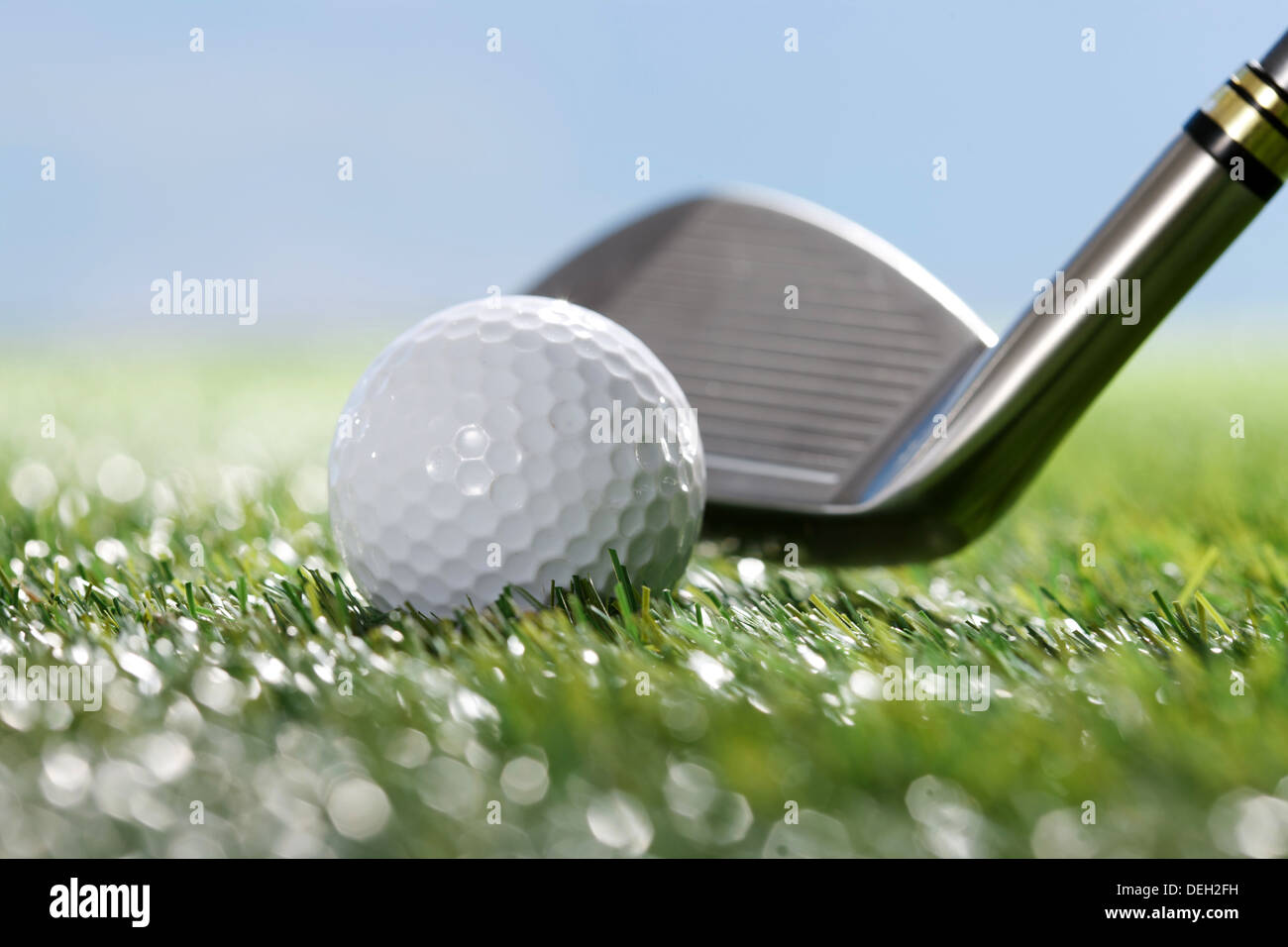 Golf club teeing up to hit ball Stock Photo - Alamy
