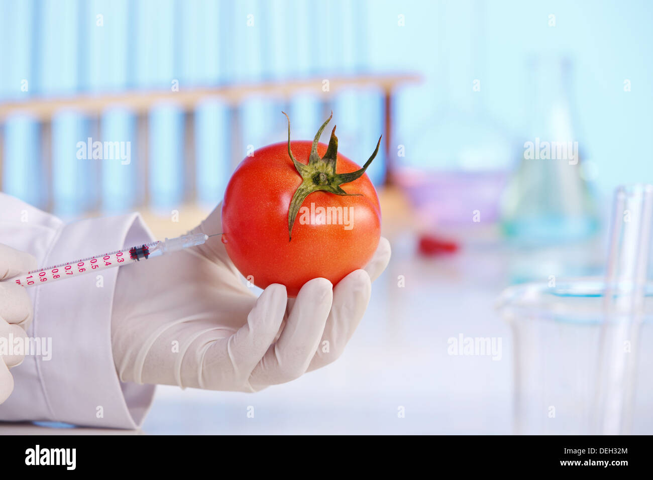 Scientist giving tomato an injection by syringe Stock Photo - Alamy