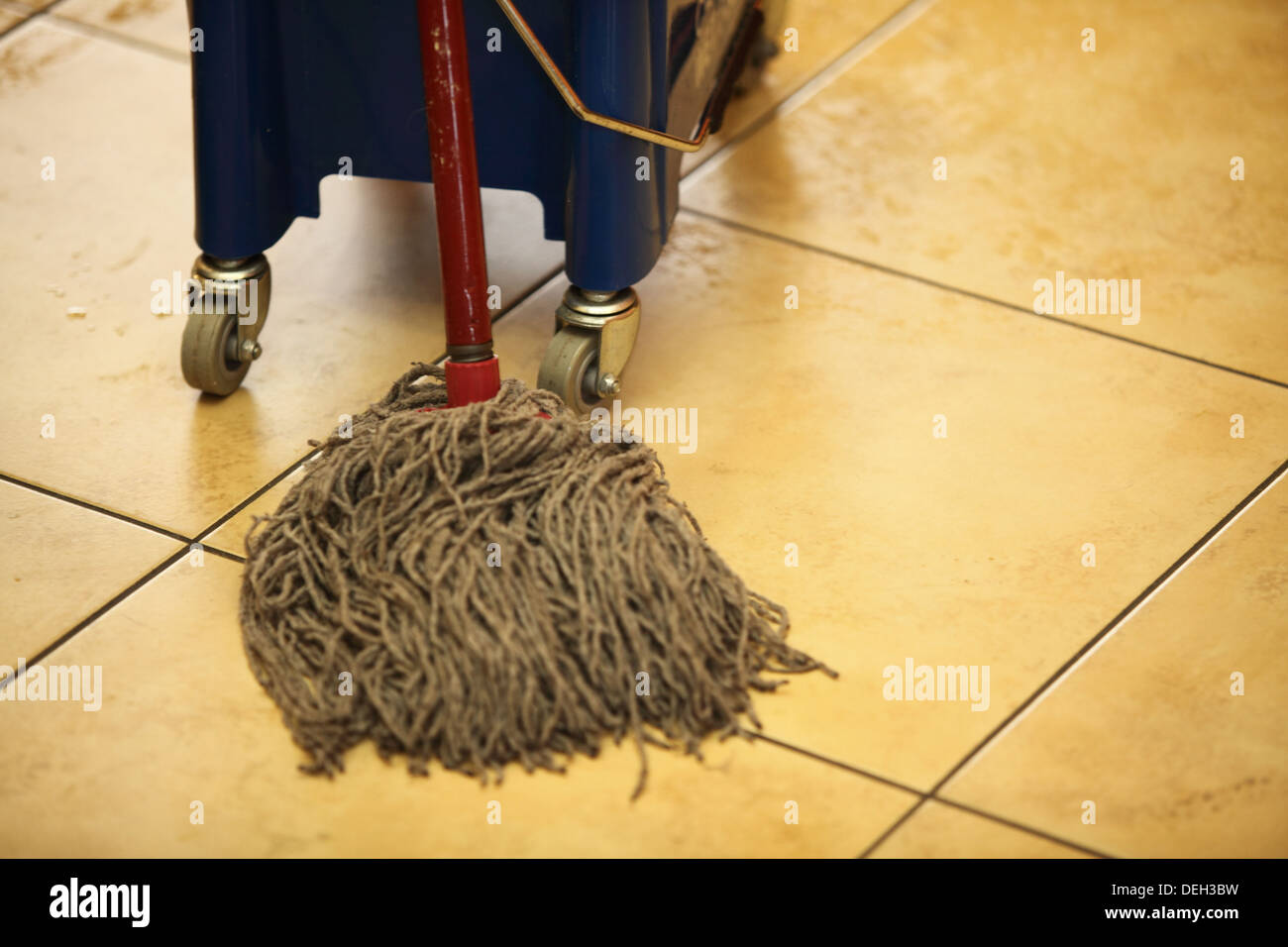 cleaning the floor with a old mop, mopping Stock Photo - Alamy