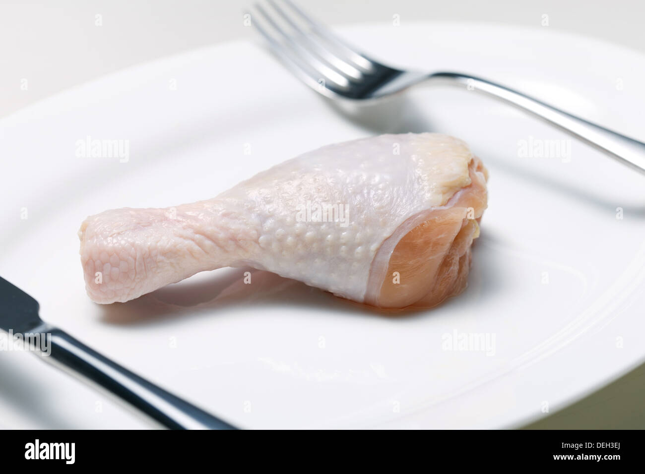 chicken leg and cutlery Stock Photo - Alamy