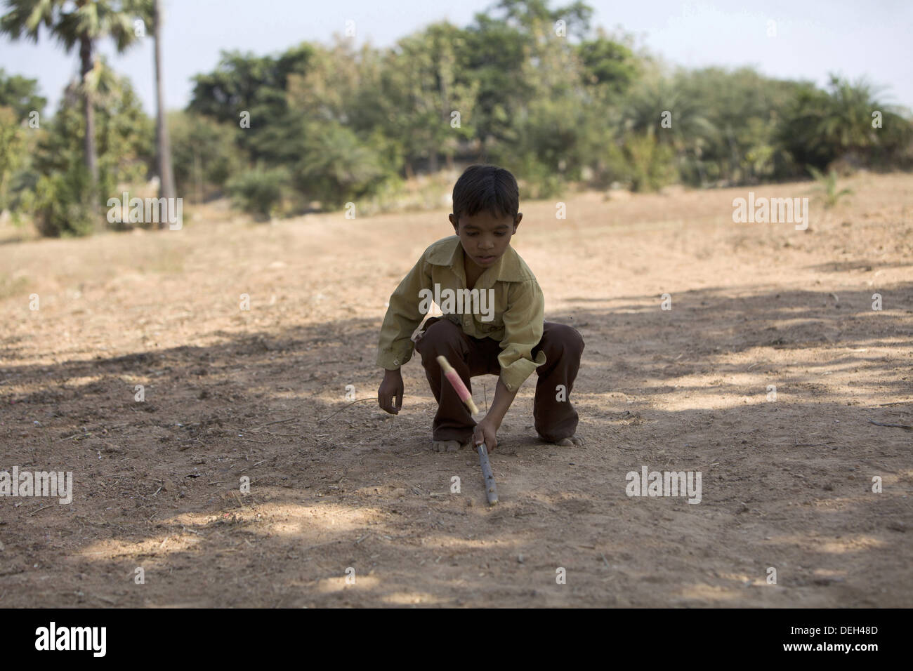 Boys playing Gilli Danda, Bhil tribe, Madhya Pradesh, Chada near ...