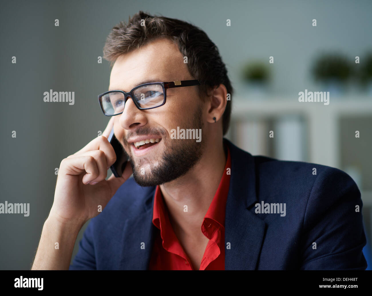 Handsome businessman in smart casual and eyeglasses speaking on the ...