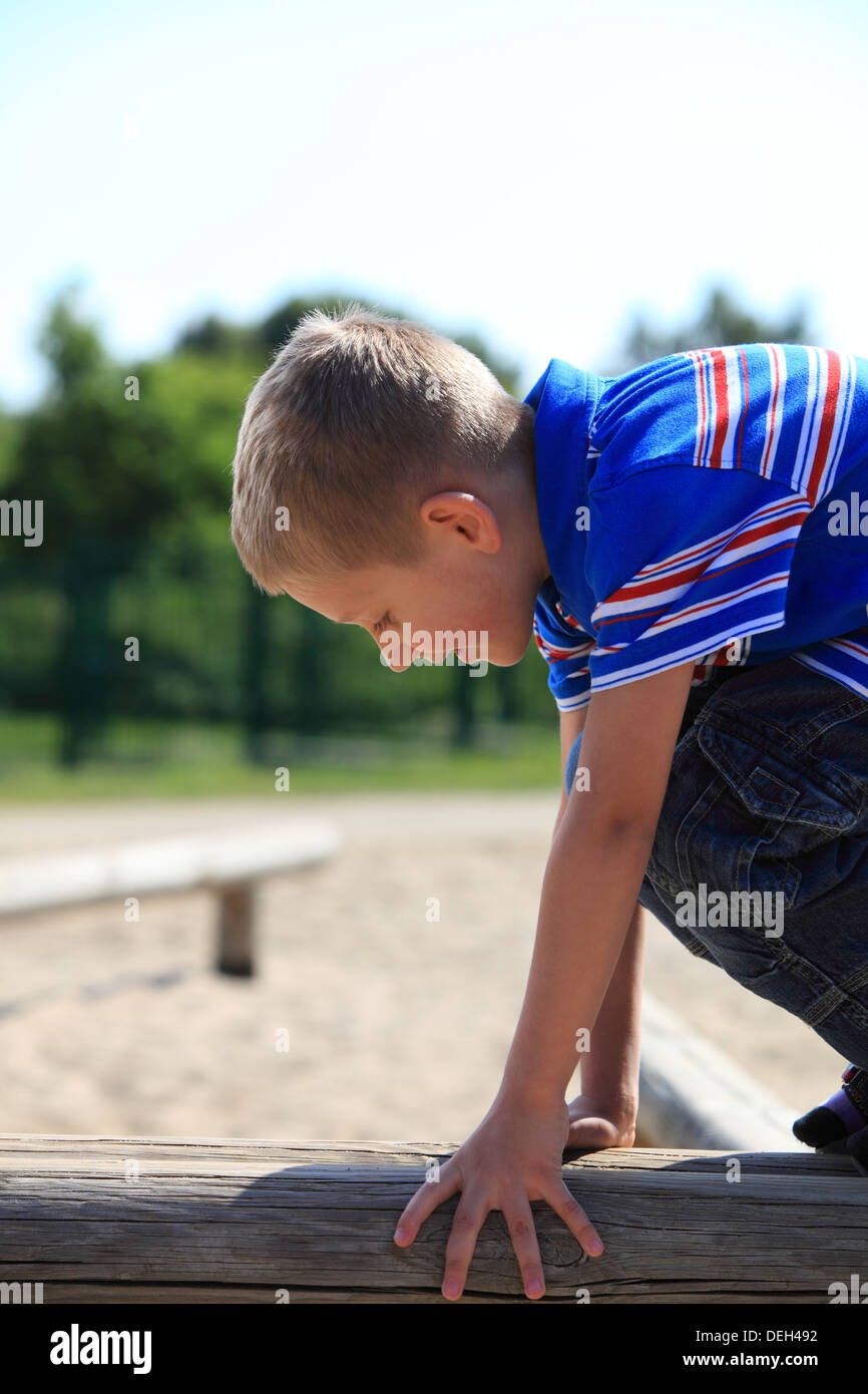 child in playground kid in action boy play on leisure equipment Stock ...