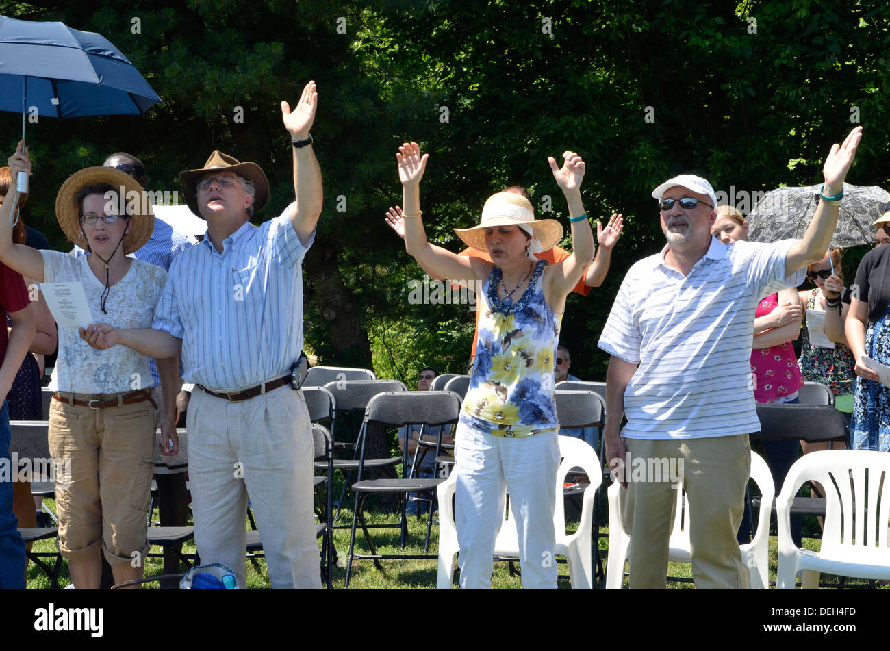 people worshiping in a outside church service Stock Photo - Alamy