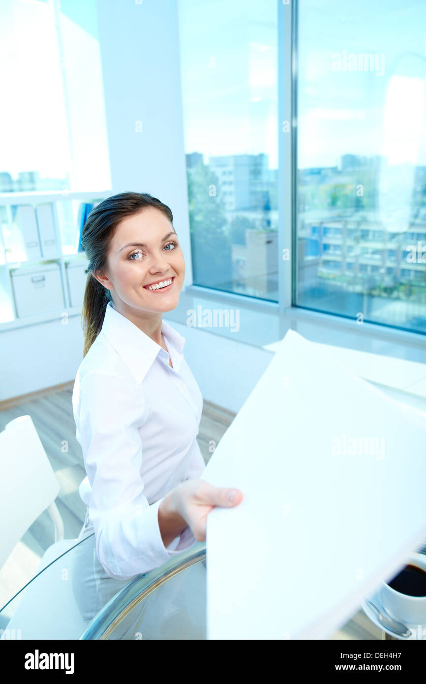 Portrait of young smiling female giving application to conductor Stock ...