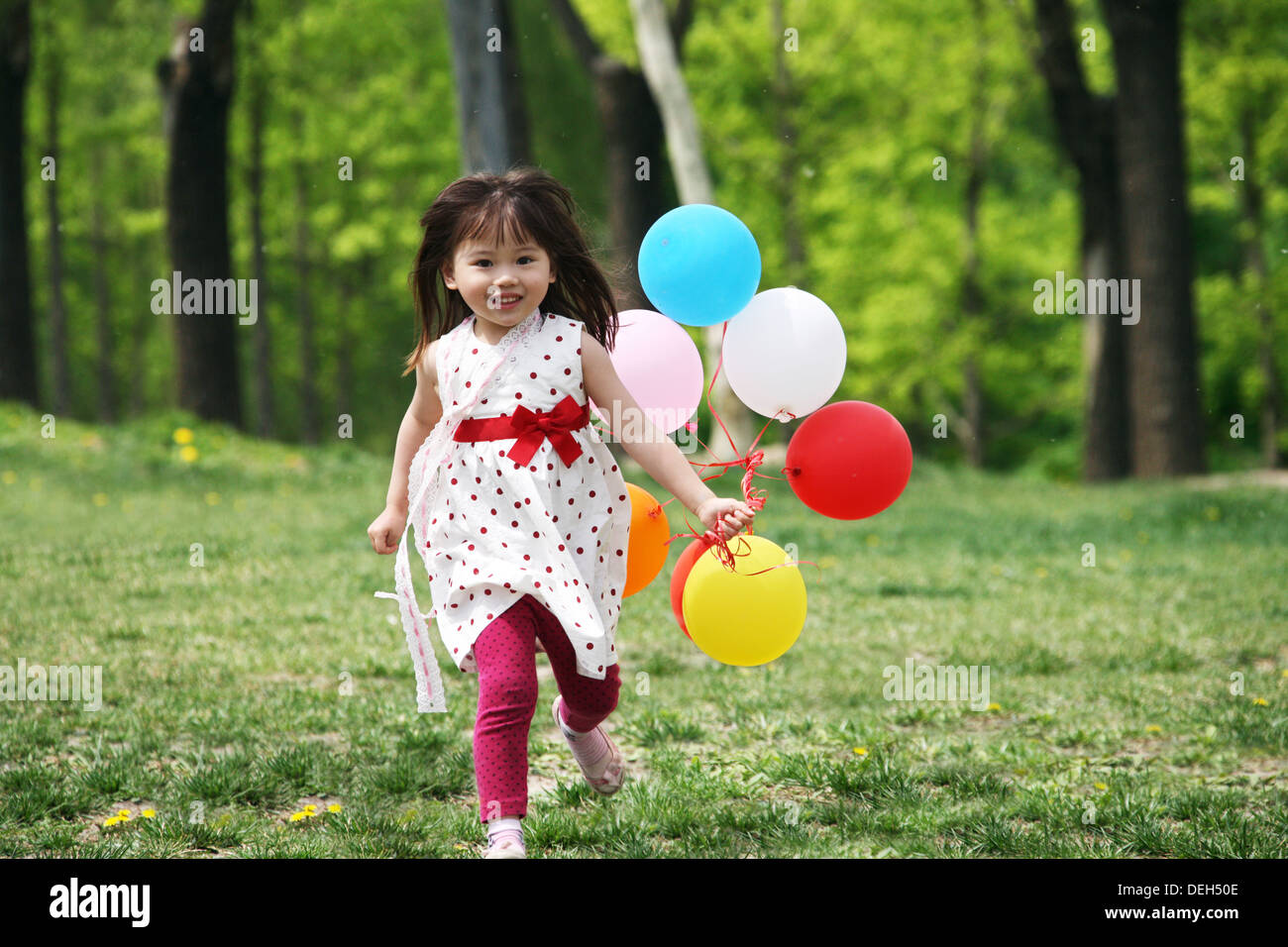 A girl playing outside Stock Photo - Alamy