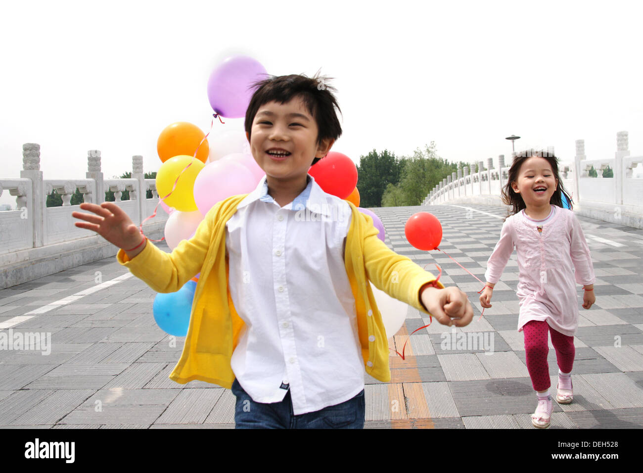 Oriental children playing outdoors Stock Photo - Alamy
