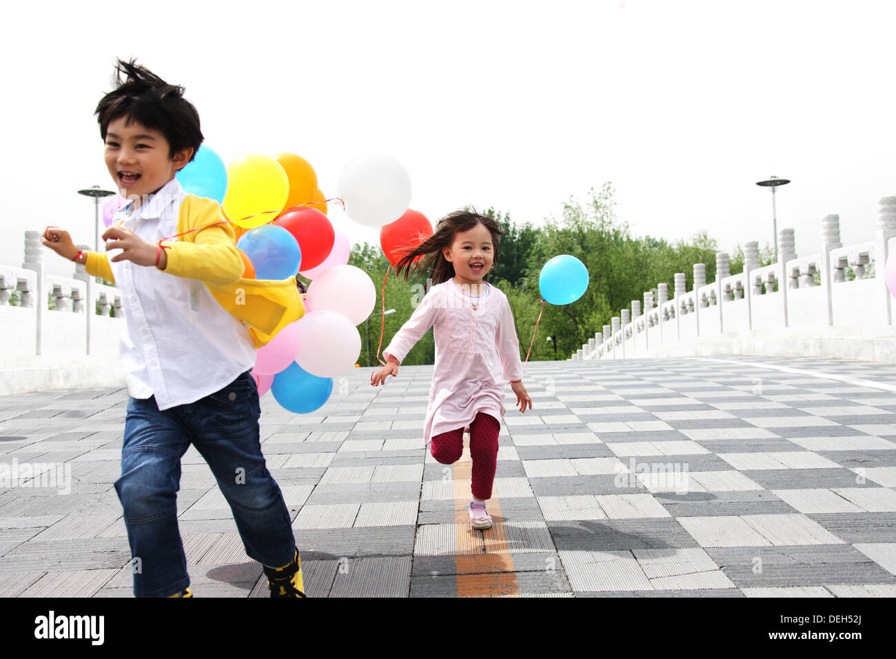 Oriental children playing outdoors Stock Photo - Alamy