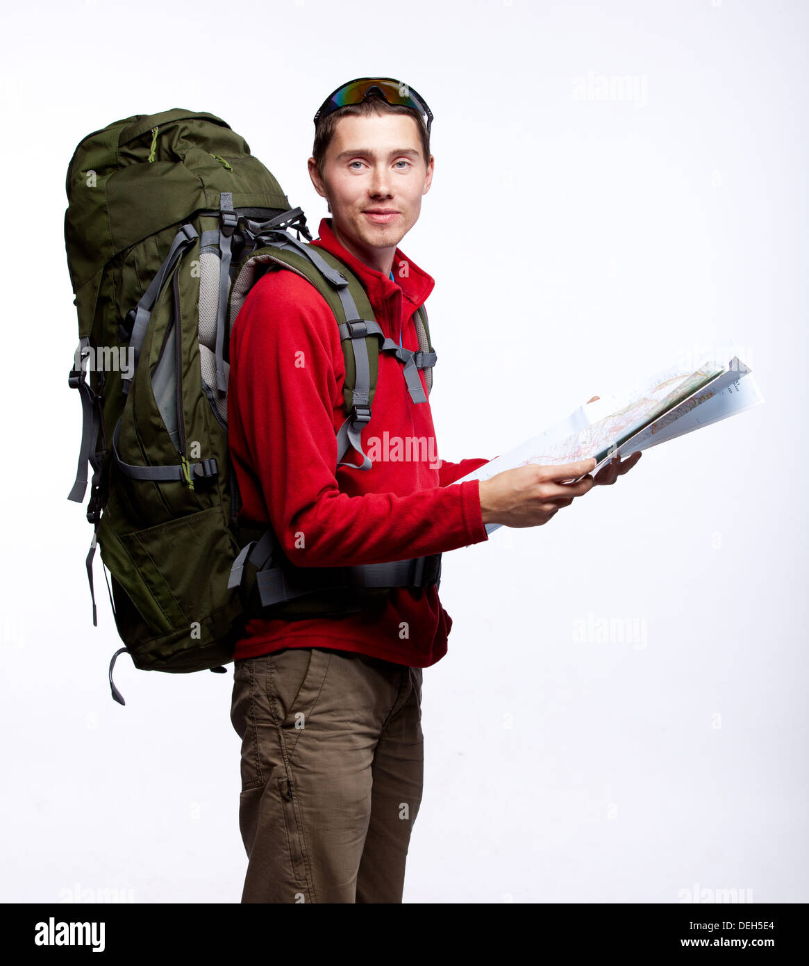 Lost hiker looking at map isolated on white background Stock Photo - Alamy