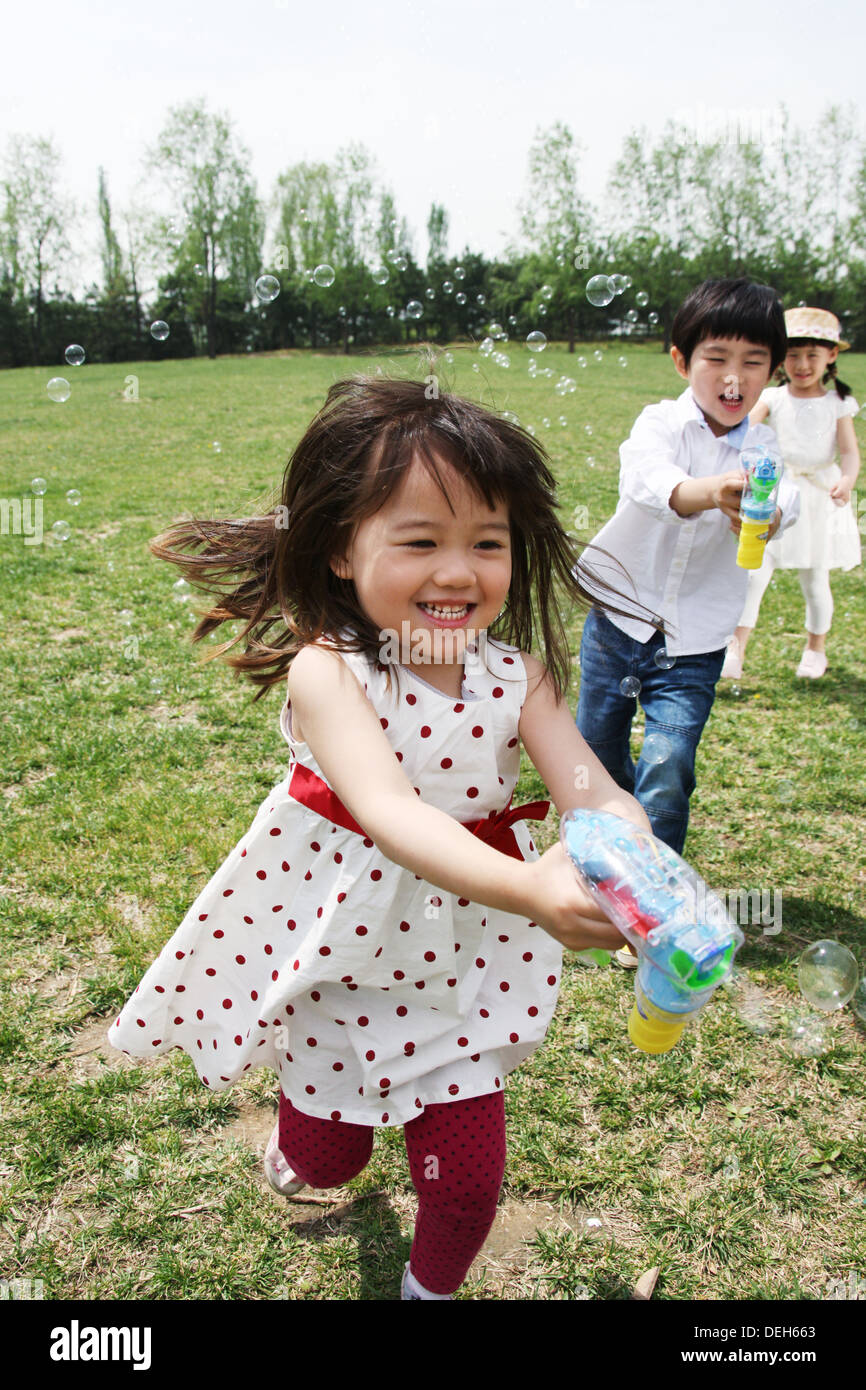 Oriental children playing outdoors Stock Photo - Alamy