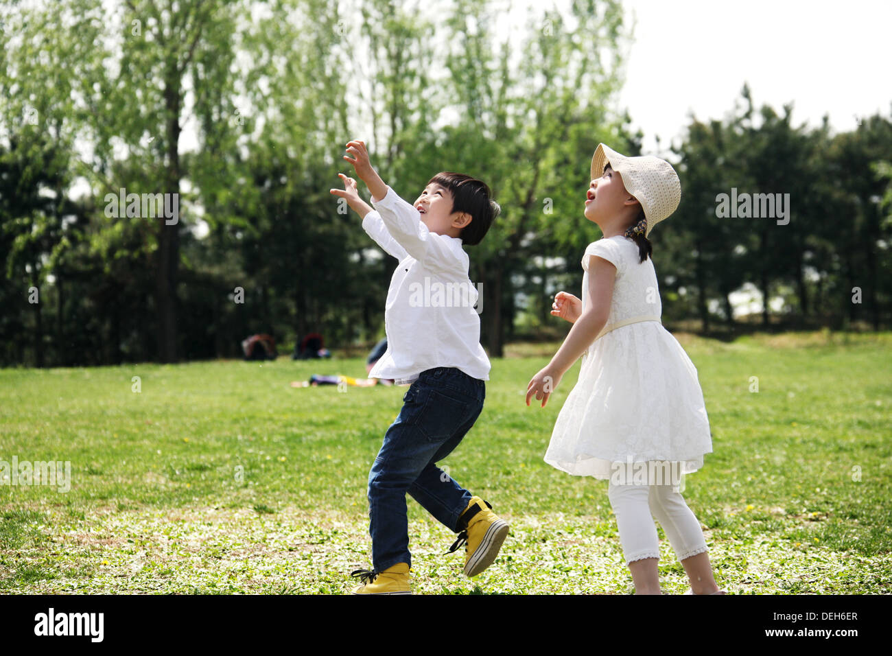 Oriental children playing outdoors Stock Photo - Alamy