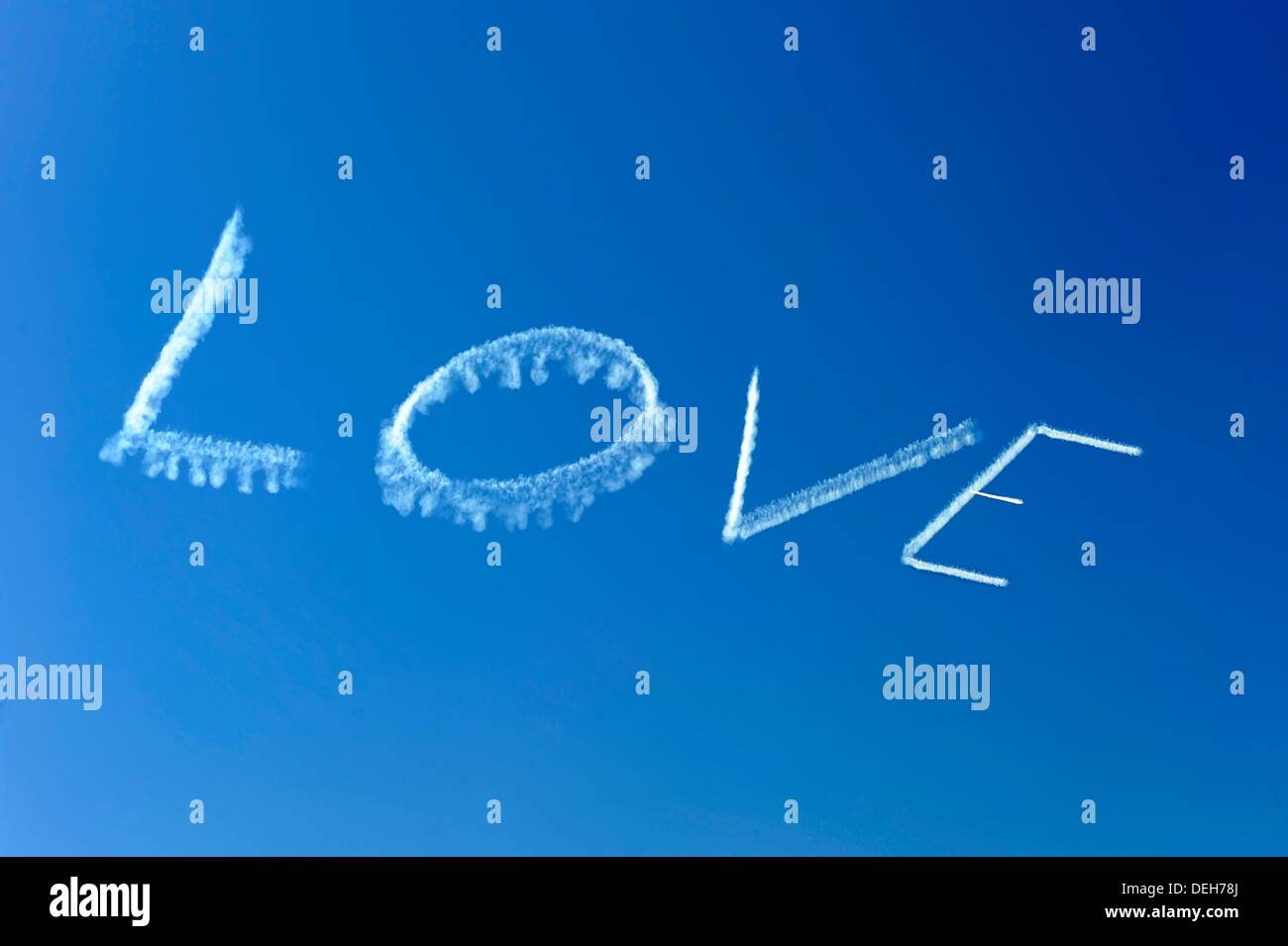Sky writing airplane with Love theme Stock Photo - Alamy