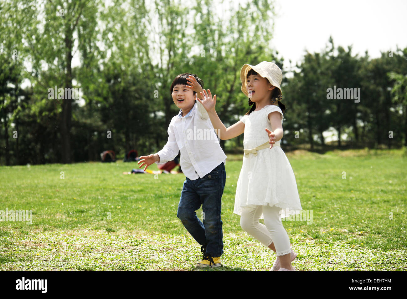 Oriental children playing outdoors Stock Photo - Alamy