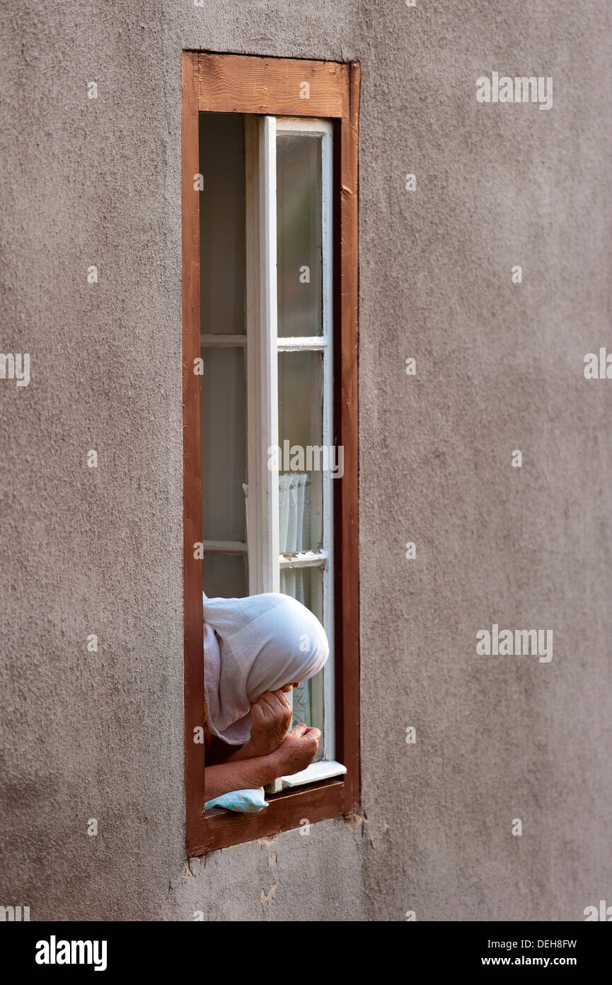 woman looking out the window, Sarajevo, capital of Bosnia and ...