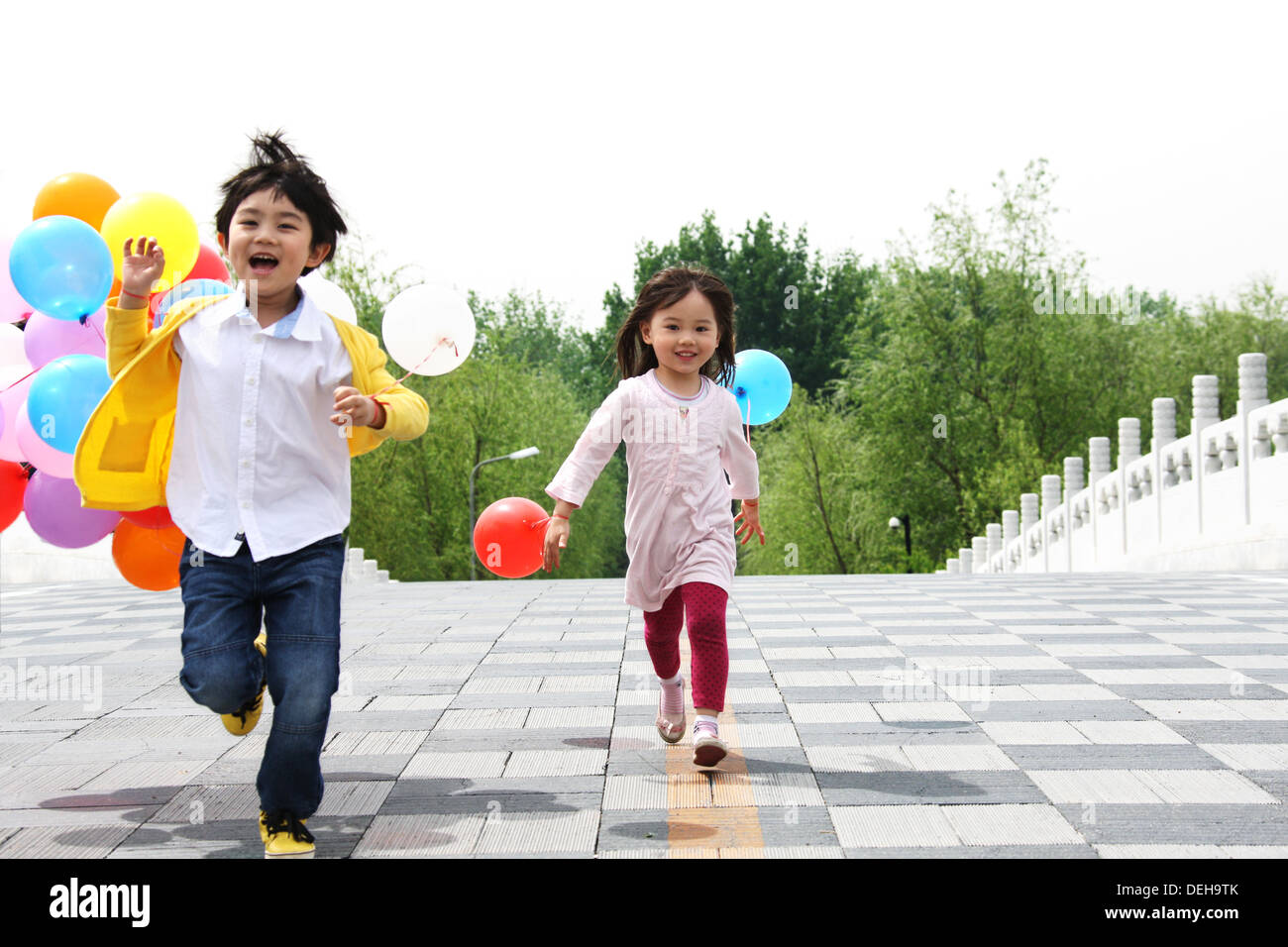 Oriental children playing outdoors Stock Photo - Alamy