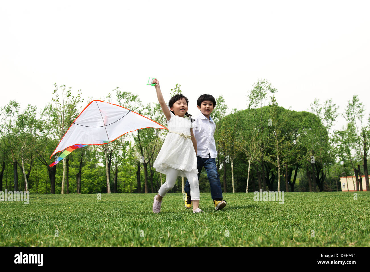 Oriental children playing kite outside Stock Photo - Alamy