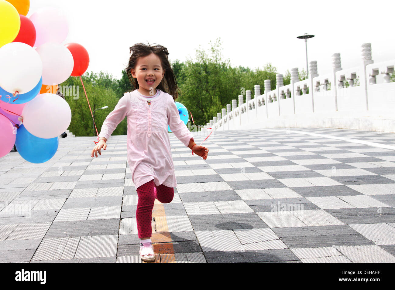 A girl playing outside Stock Photo - Alamy