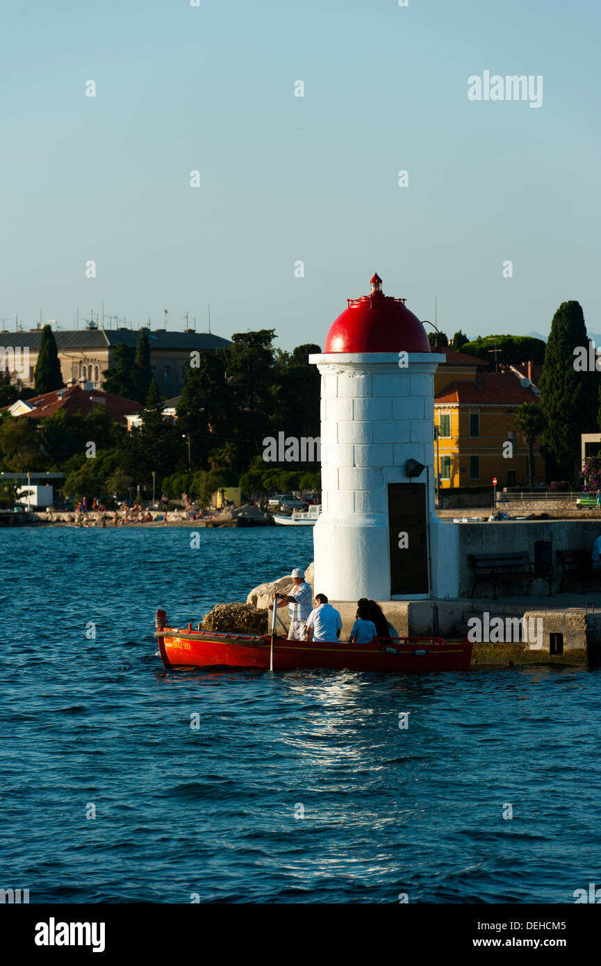 Boat in front of lighthouse, Zadar, Zadar county, Dalmatian region ...