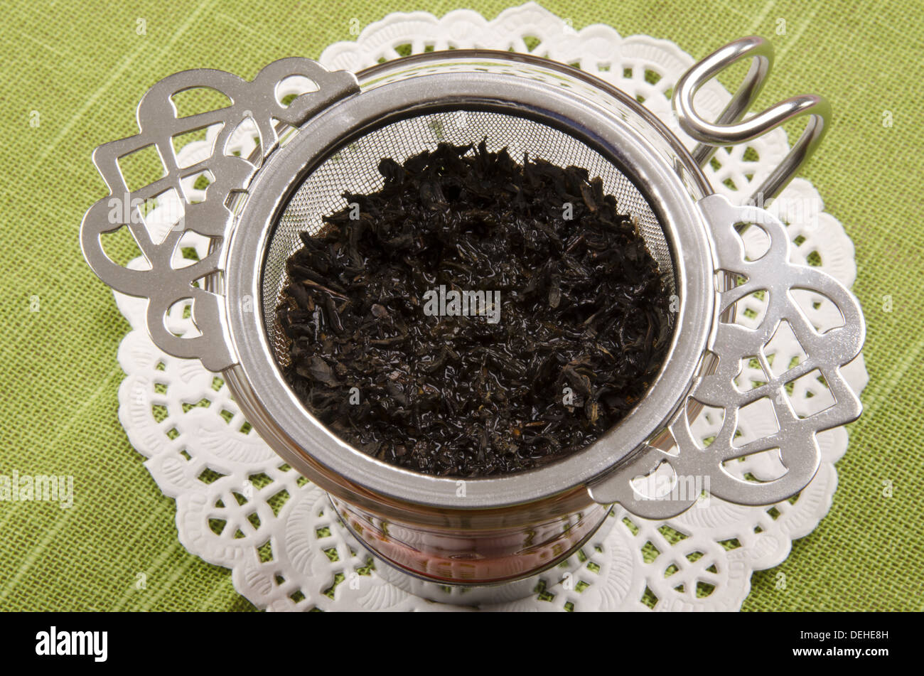 teacup with fresh made tea and a tea strainer Stock Photo - Alamy
