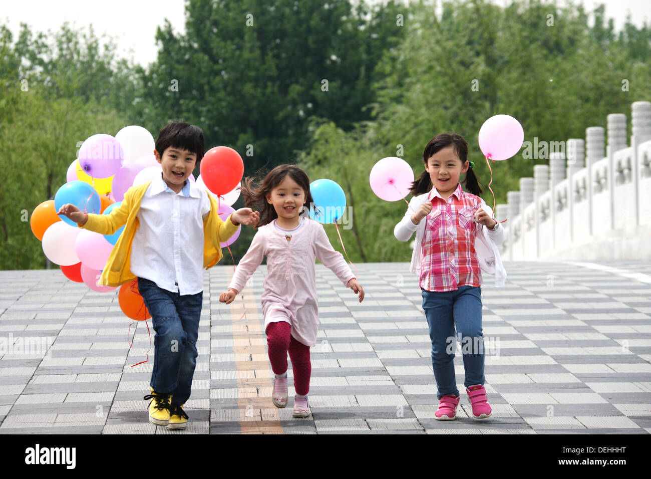 Oriental children playing outdoors Stock Photo - Alamy