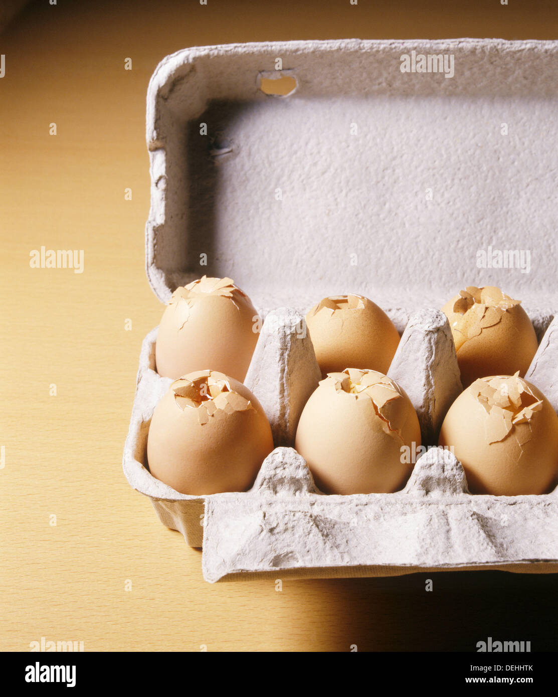 Cardboard egg carton with shattered eggs Stock Photo - Alamy