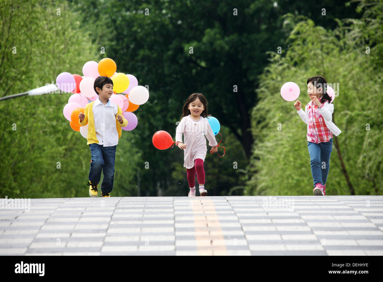 Oriental children playing outdoors Stock Photo - Alamy