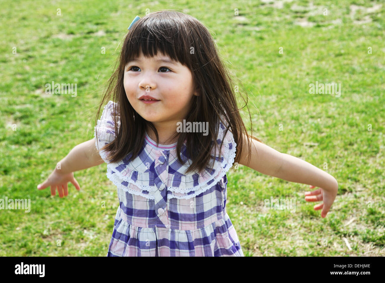 A girl playing outside Stock Photo - Alamy