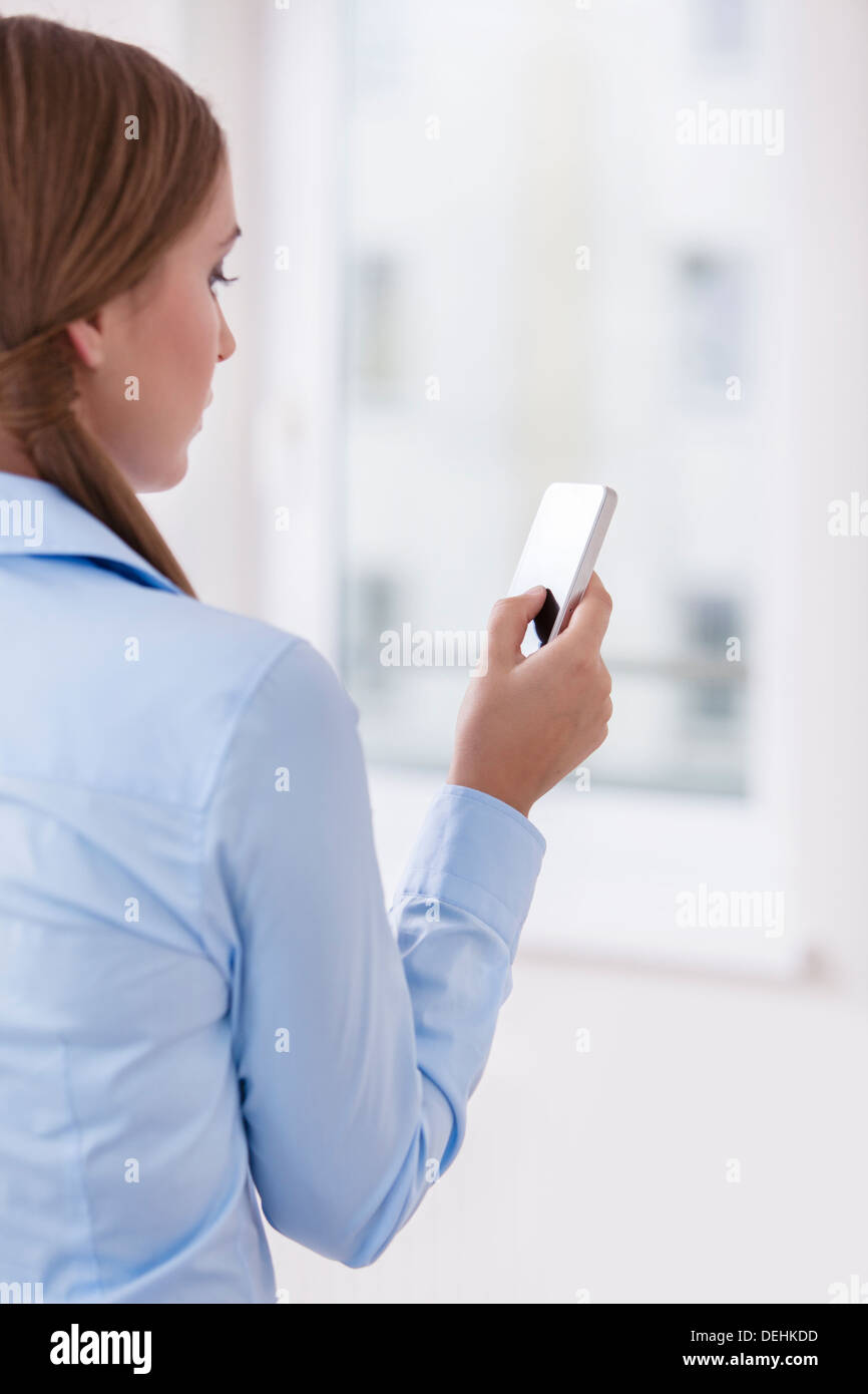 Woman looking at phone rear view hi-res stock photography and images ...