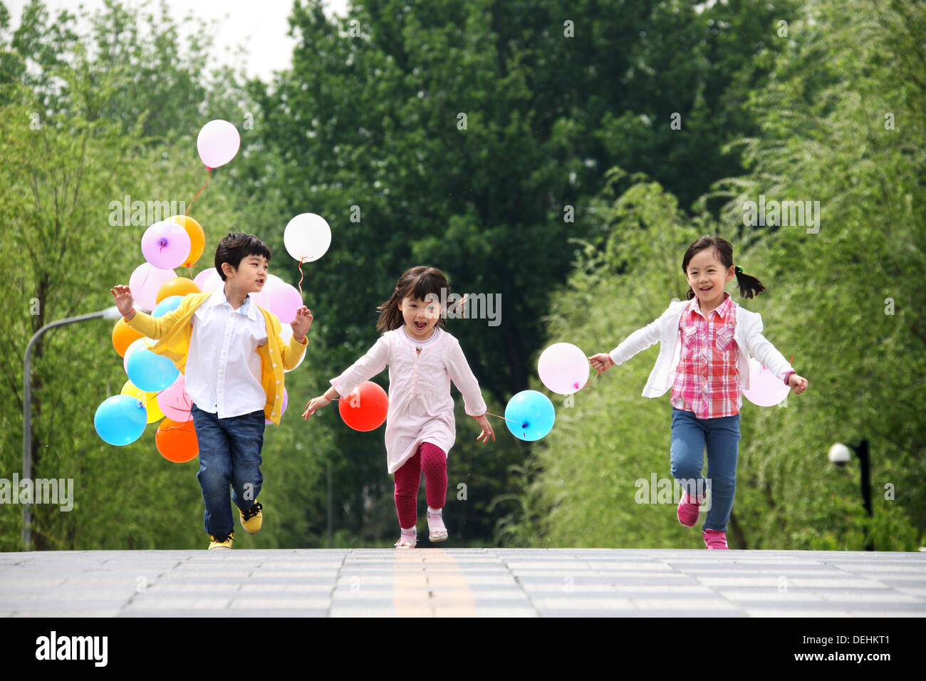 Oriental children playing outdoors Stock Photo - Alamy