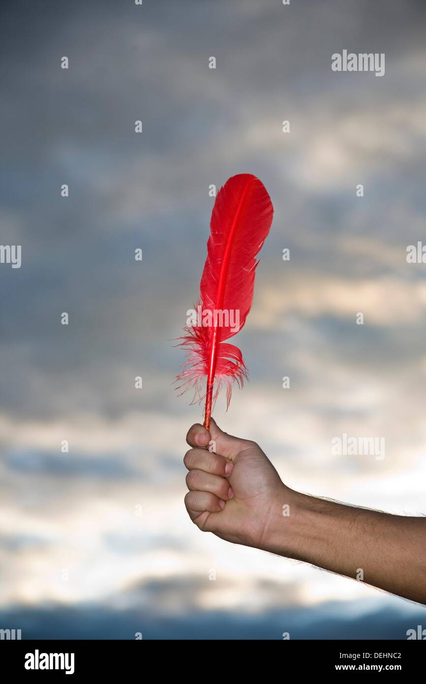 Hand and feather hi-res stock photography and images - Alamy