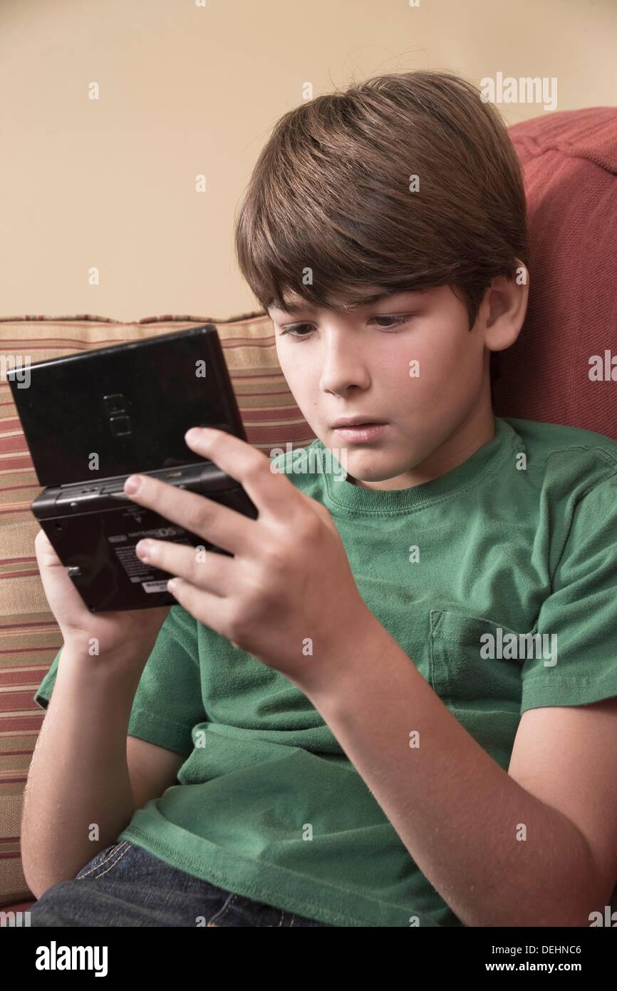 Young boy playing a video game Stock Photo - Alamy