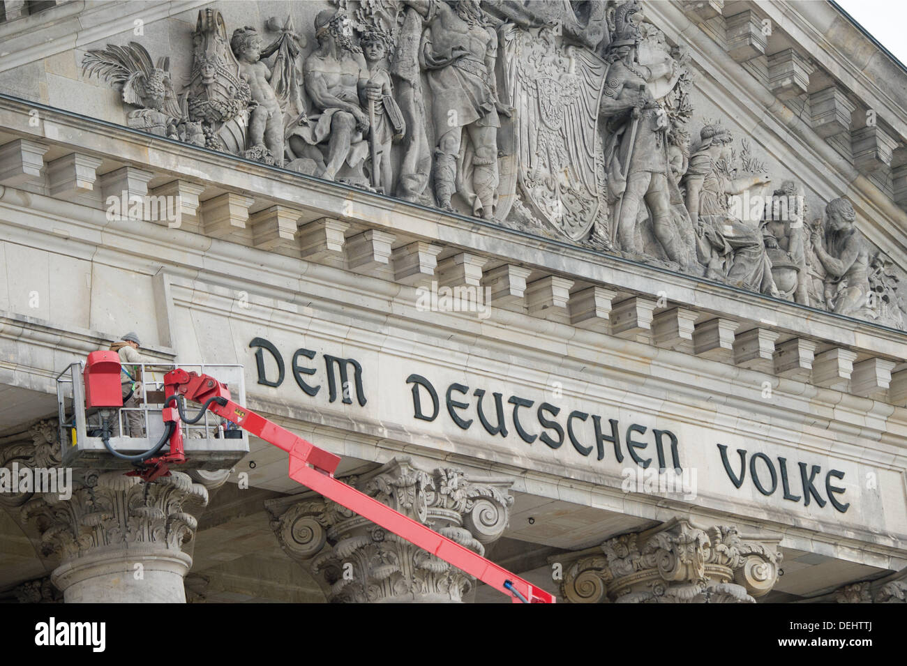 A cart is lifted up to the facade of the Reichstag building in Berlin ...