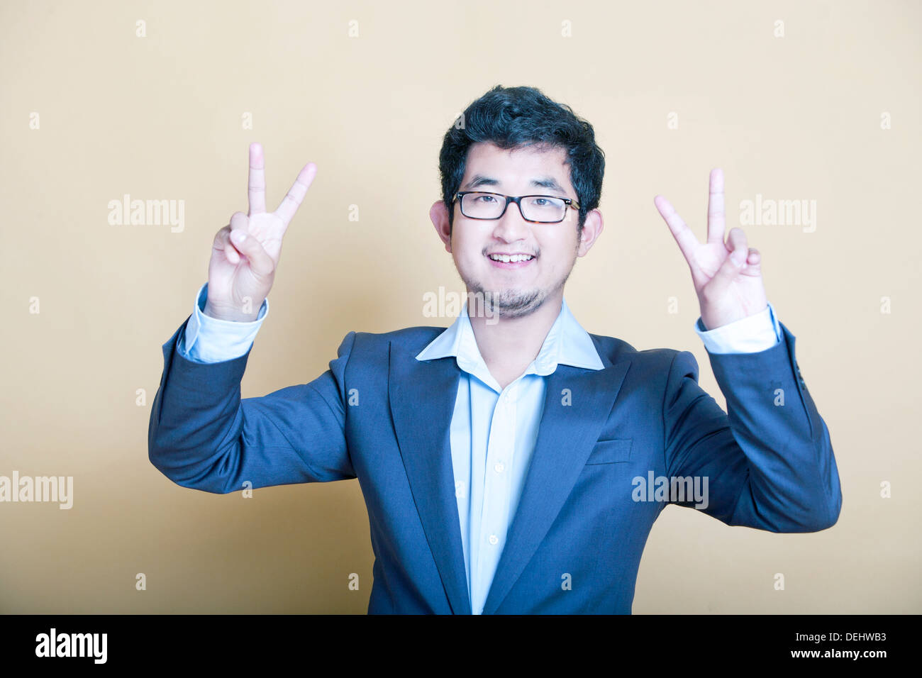 Stylish Asian man making 'peace' symbols Stock Photo - Alamy