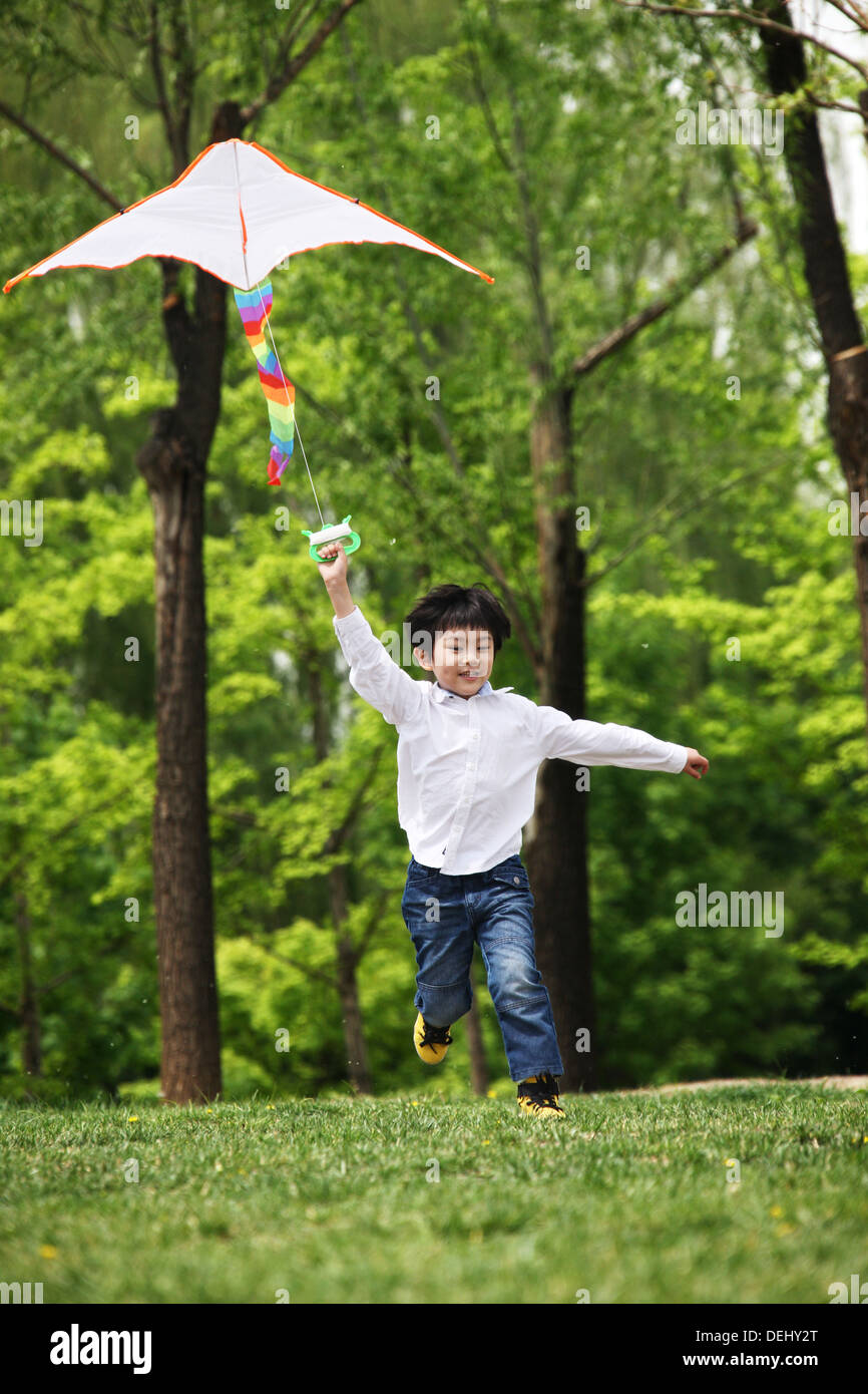 A girl playing kite outside Stock Photo - Alamy