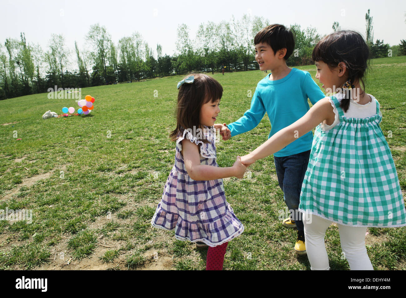 Oriental children playing outdoors Stock Photo - Alamy