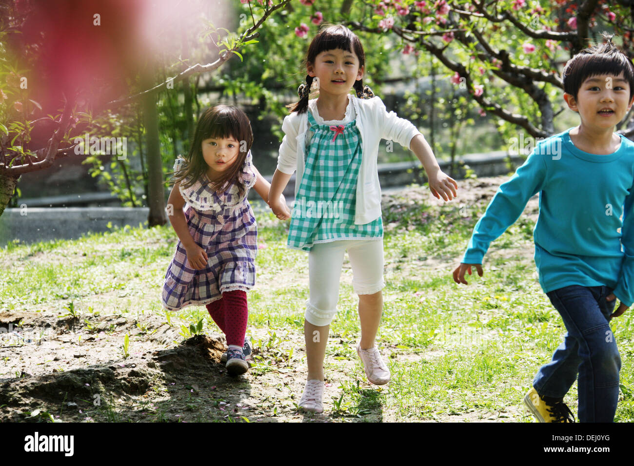 Oriental children playing outdoors Stock Photo - Alamy